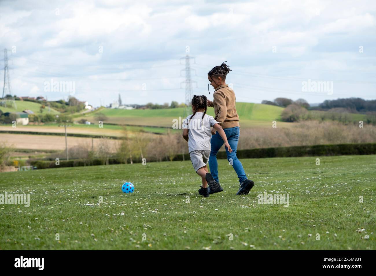 Brothers playing football Stock Photo - Alamy