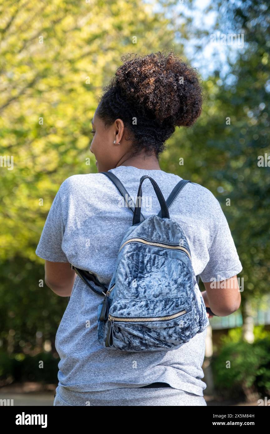 Rear view of teenage girl with backpack Stock Photo - Alamy