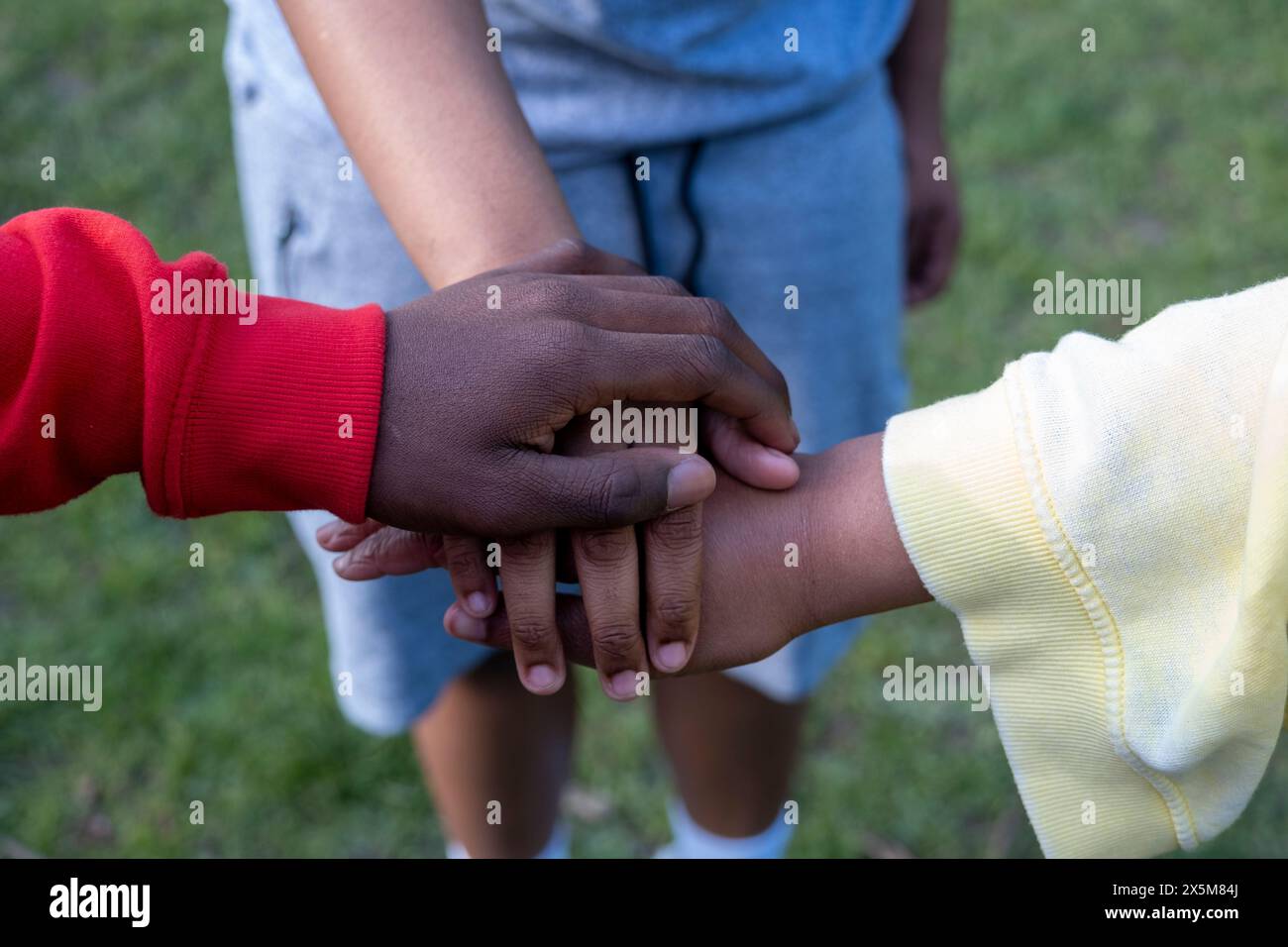 Friends stacking hands together Stock Photo - Alamy