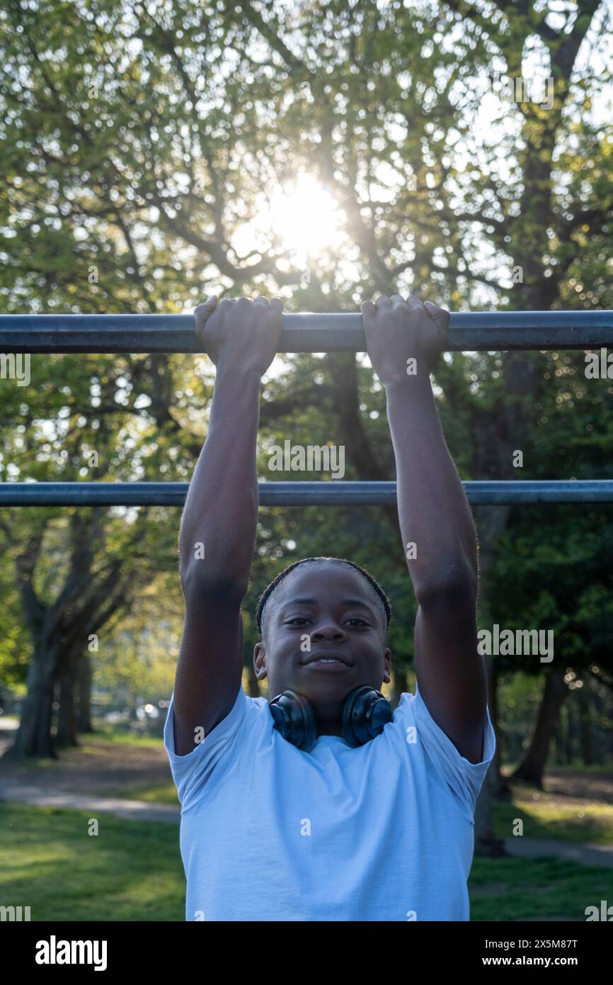 Teenage boy doing pull ups Stock Photo - Alamy