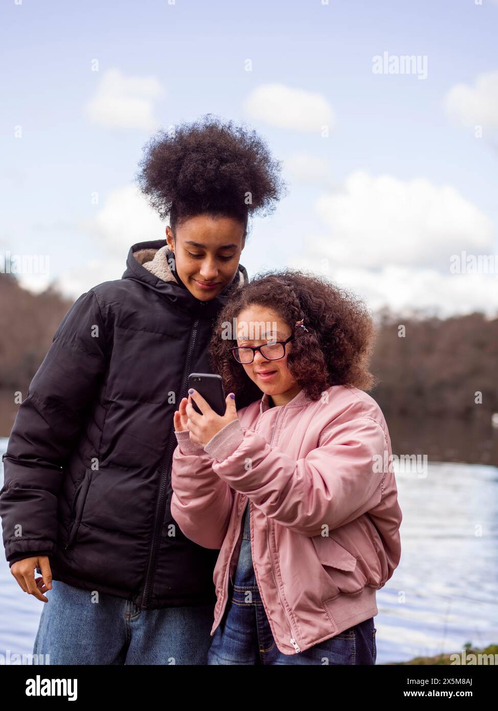Two girls with mobile phone Stock Photo - Alamy