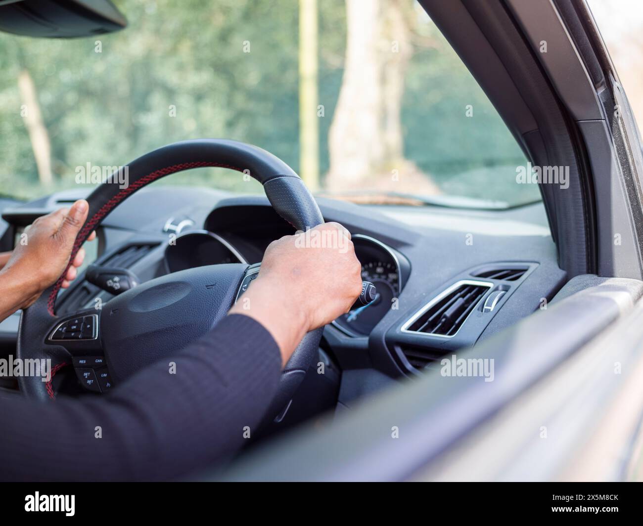 Woman driving car, view of hands Stock Photo - Alamy