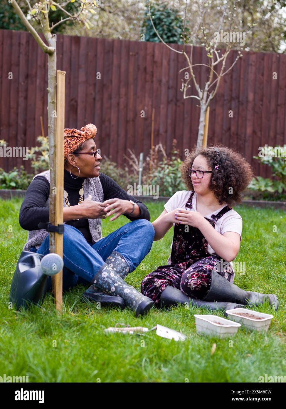 Mother and daughter talking in backyard Stock Photo - Alamy