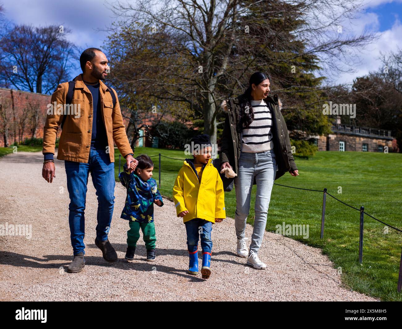 Parents with two sons in park Stock Photo - Alamy