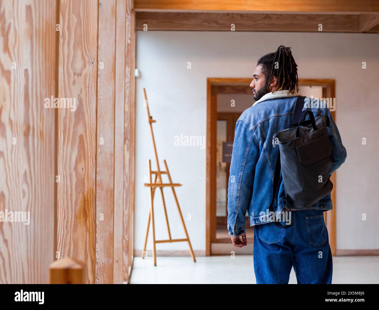 Rear view young man backpack hi-res stock photography and images - Alamy