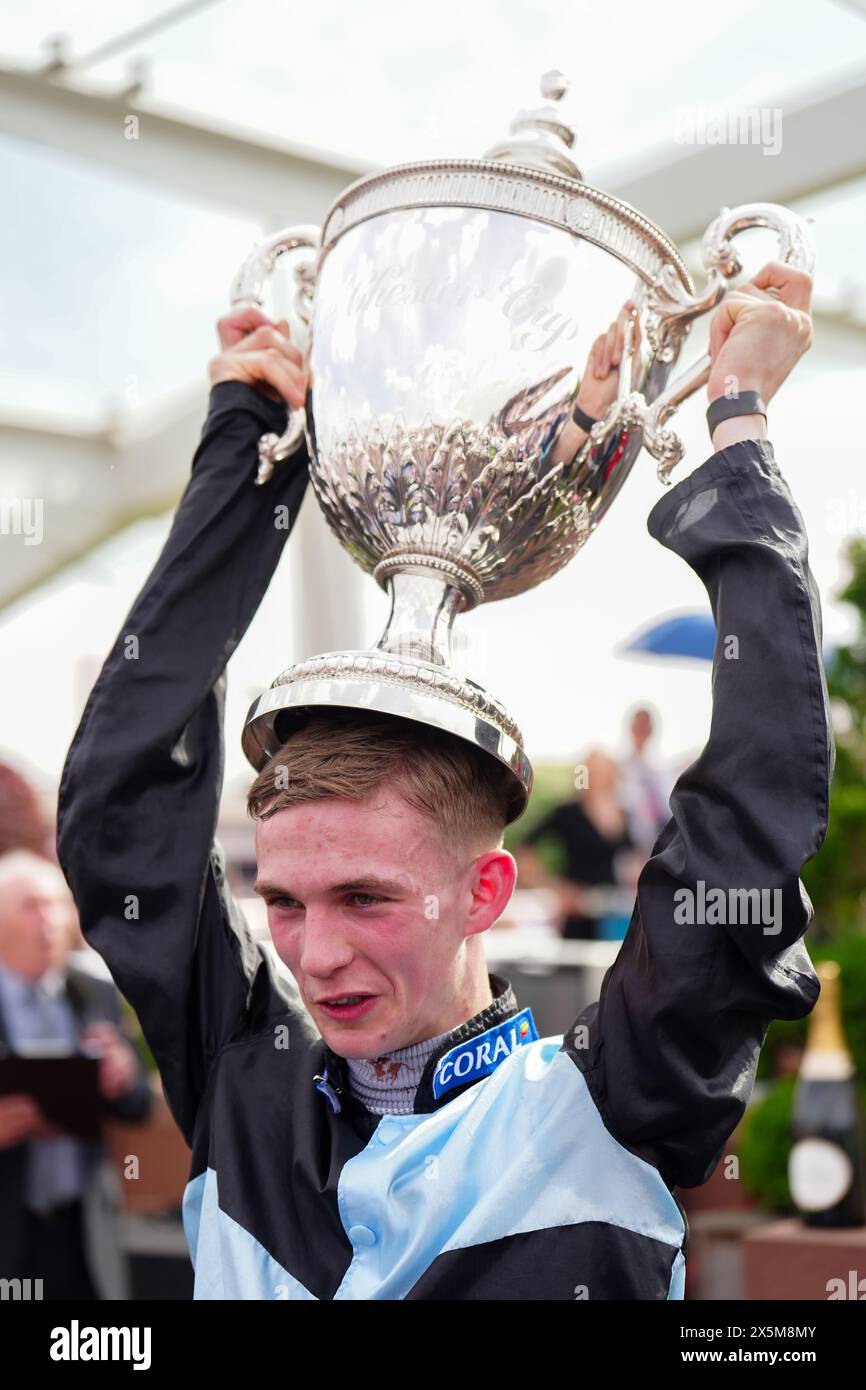 Harry Davies, Jockey of Zoffee, lifts the Chester Cup after winning the Duke Of Westminster ...