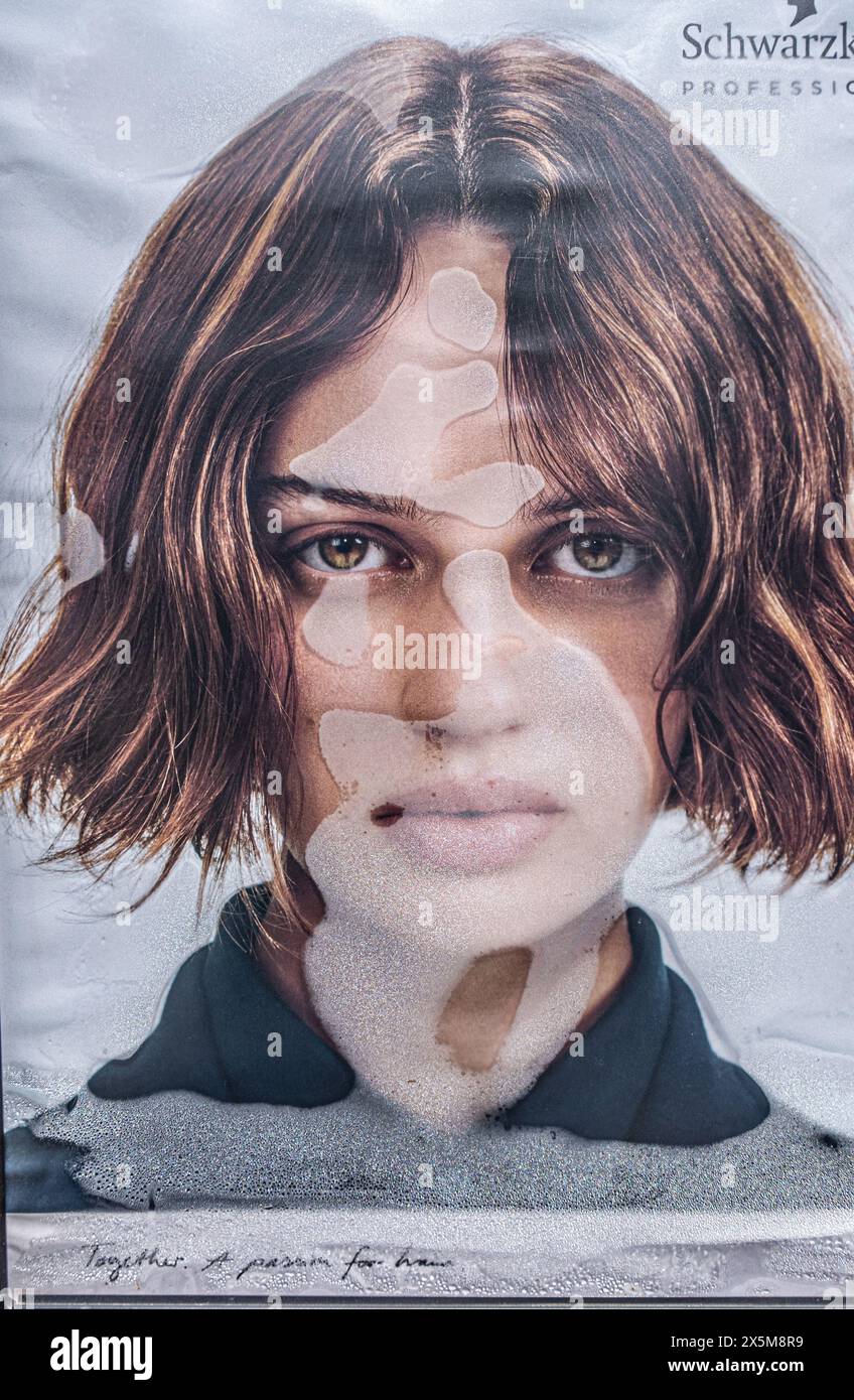 Water damaged poster advertisement for hair colouring outside ...