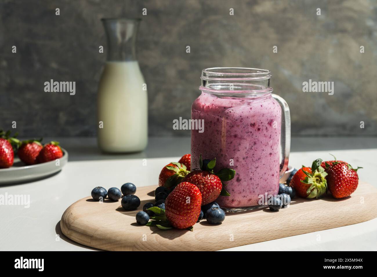 healthy red berry smoothie in a glass jar on a grey background Stock ...