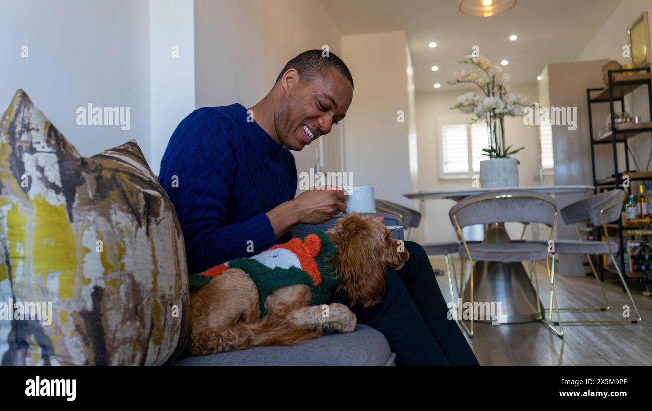 Dog sitting on owner hi-res stock photography and images - Alamy