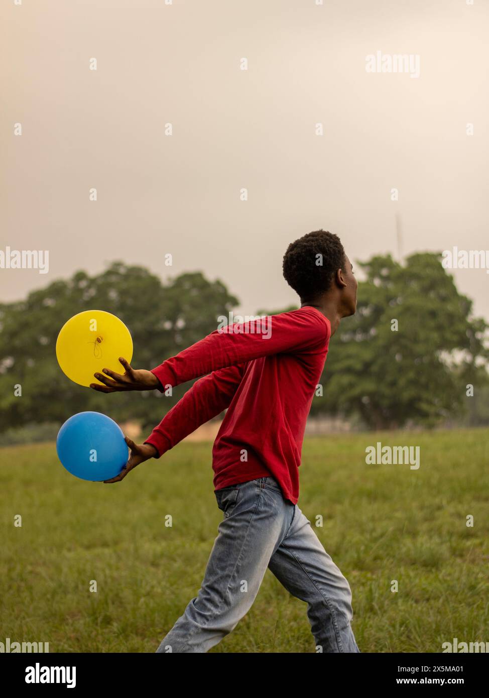 Young people playing in park hi-res stock photography and images - Alamy