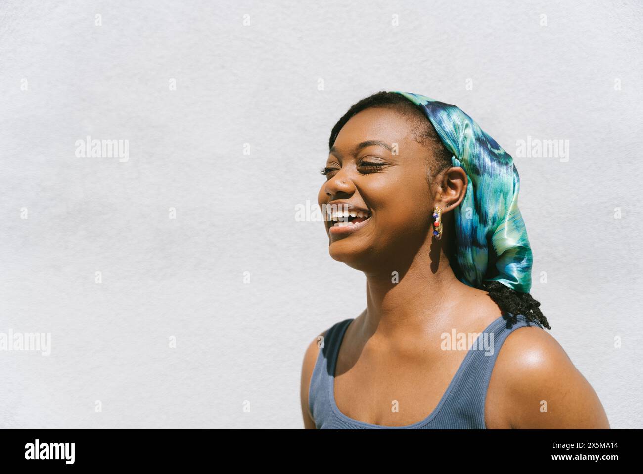 Portrait of young woman wearing blue headscarf Stock Photo - Alamy