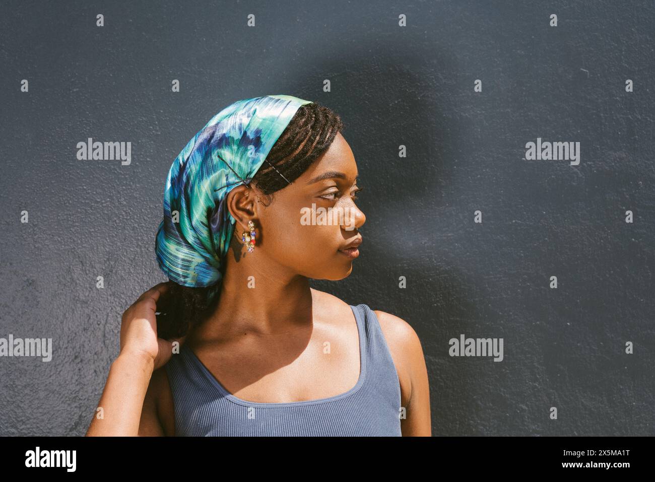 Portrait of young woman wearing blue headscarf Stock Photo - Alamy