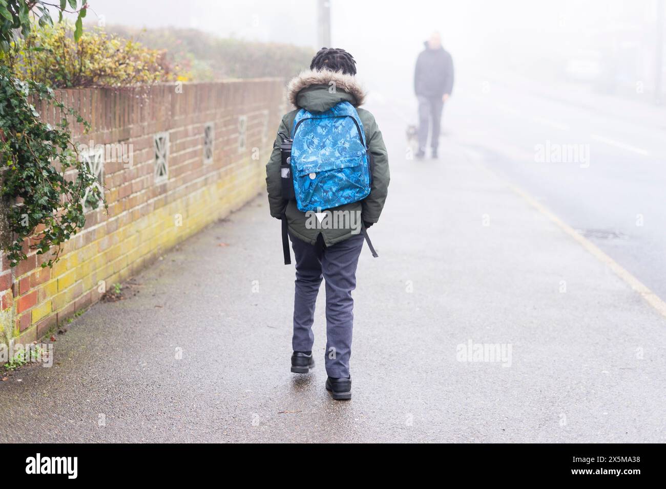 Boy walking to school Stock Photo - Alamy