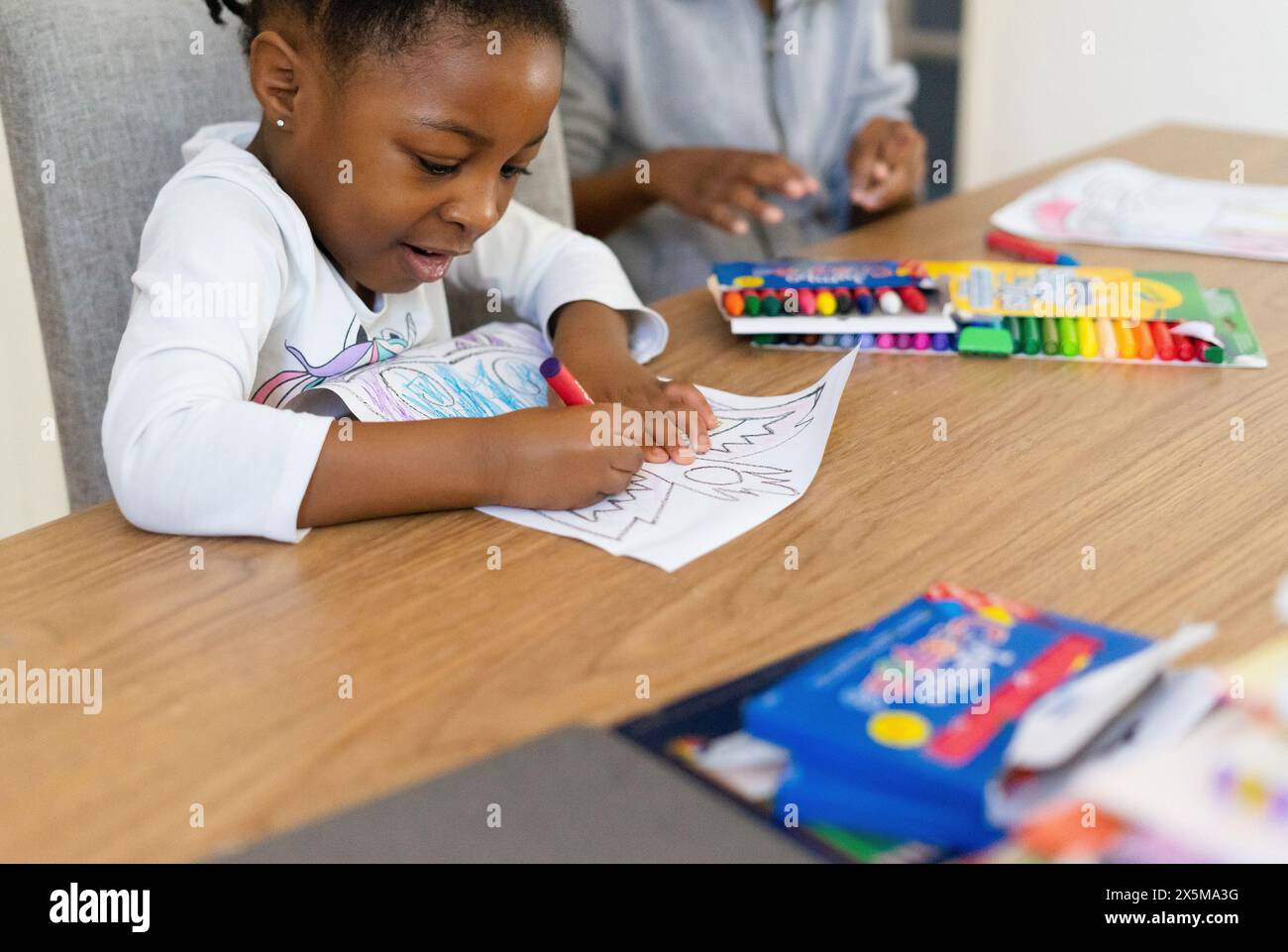 Siblings drawing at table Stock Photo - Alamy