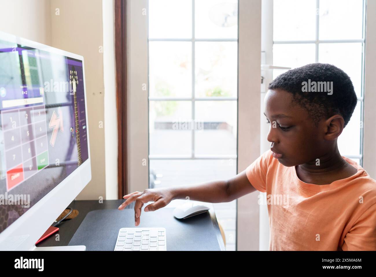 Boy using calculator on computer Stock Photo - Alamy
