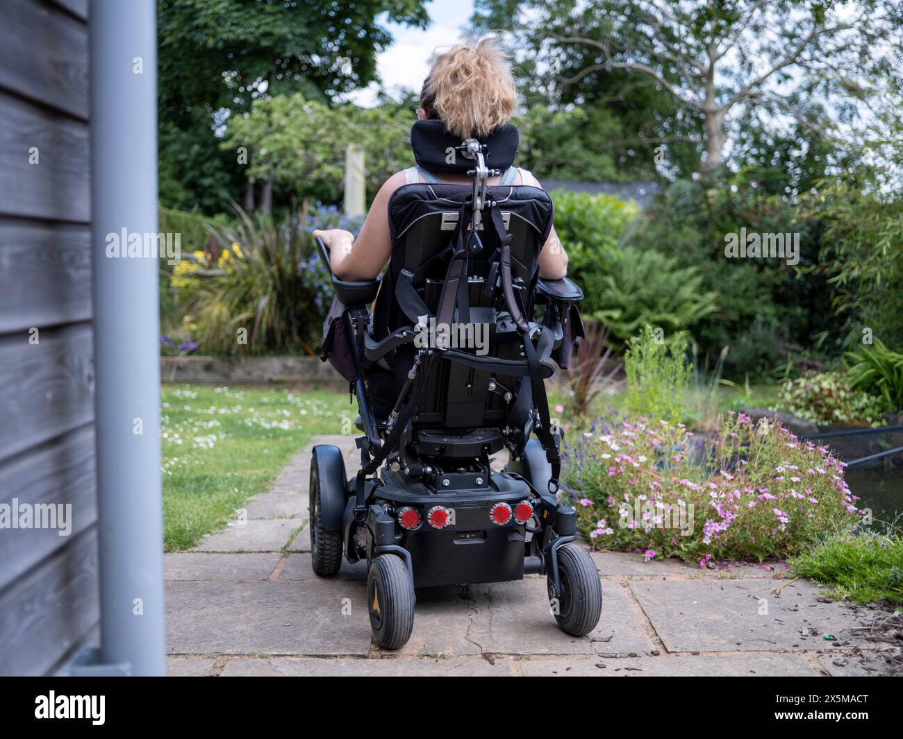 Woman in electric wheelchair outdoors Stock Photo - Alamy