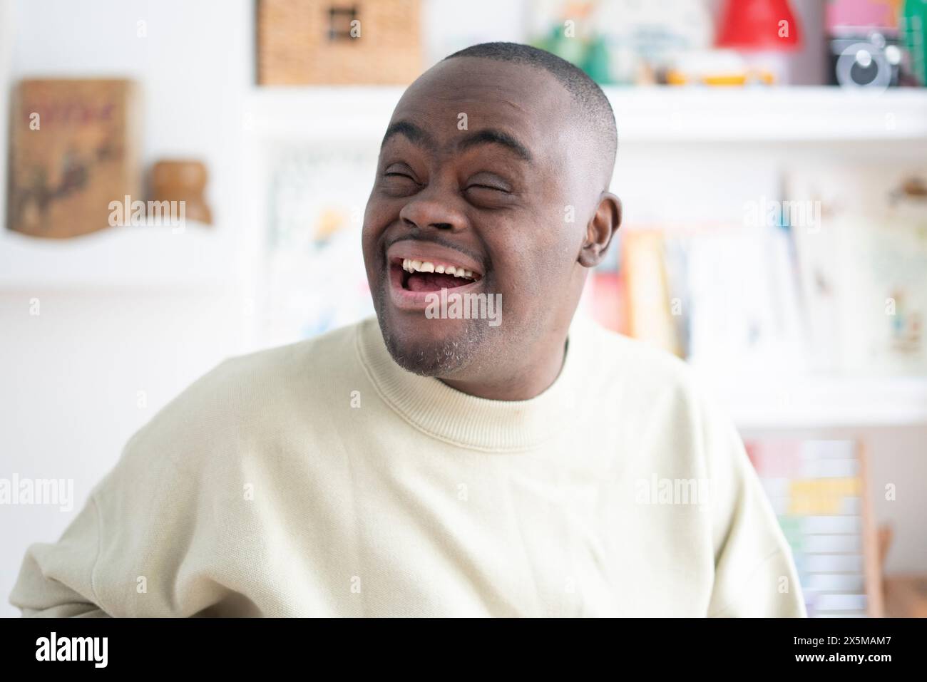 Smiling man with Down syndrome Stock Photo - Alamy