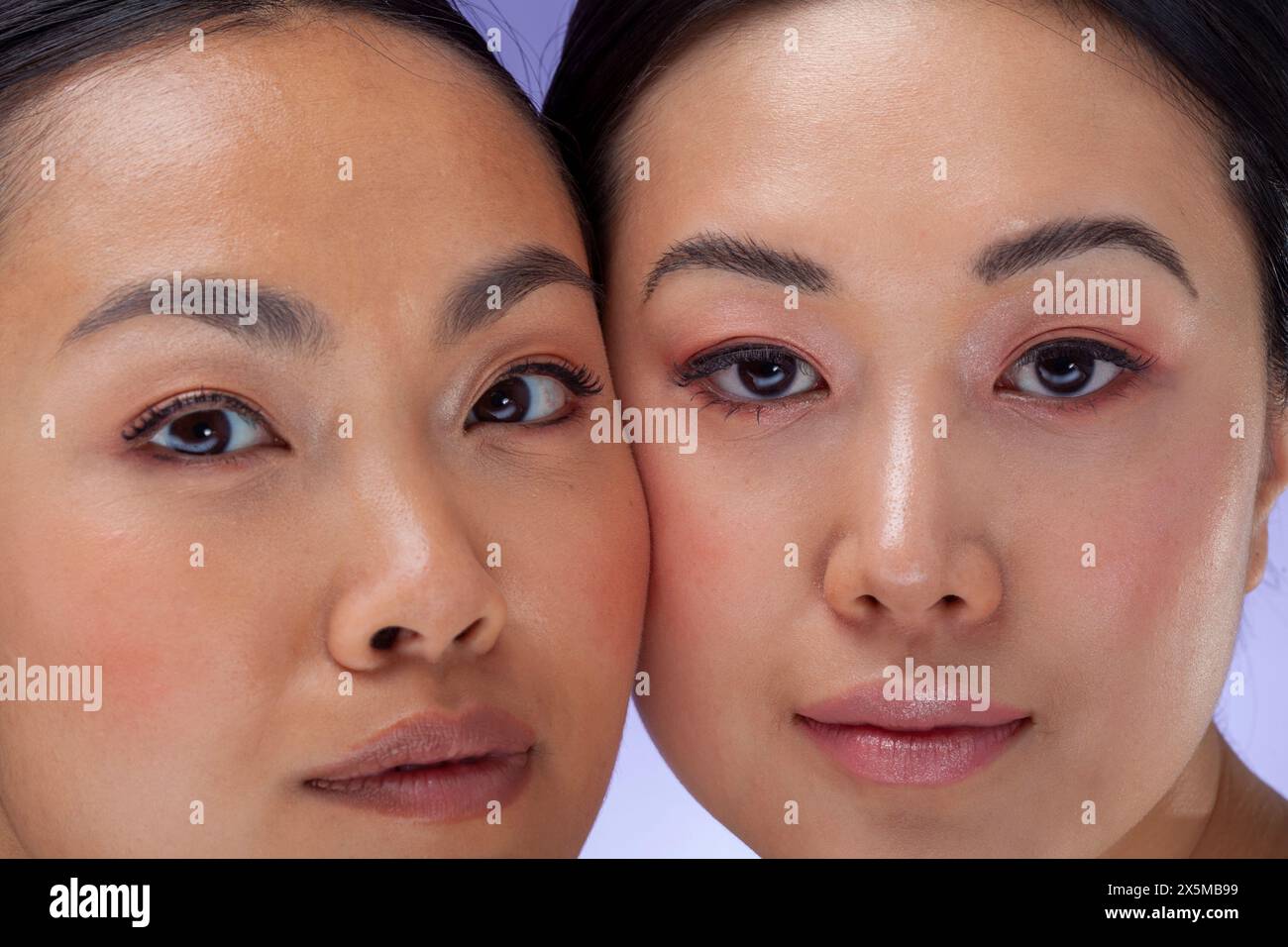 Close-up of two women cheek to cheek Stock Photo - Alamy