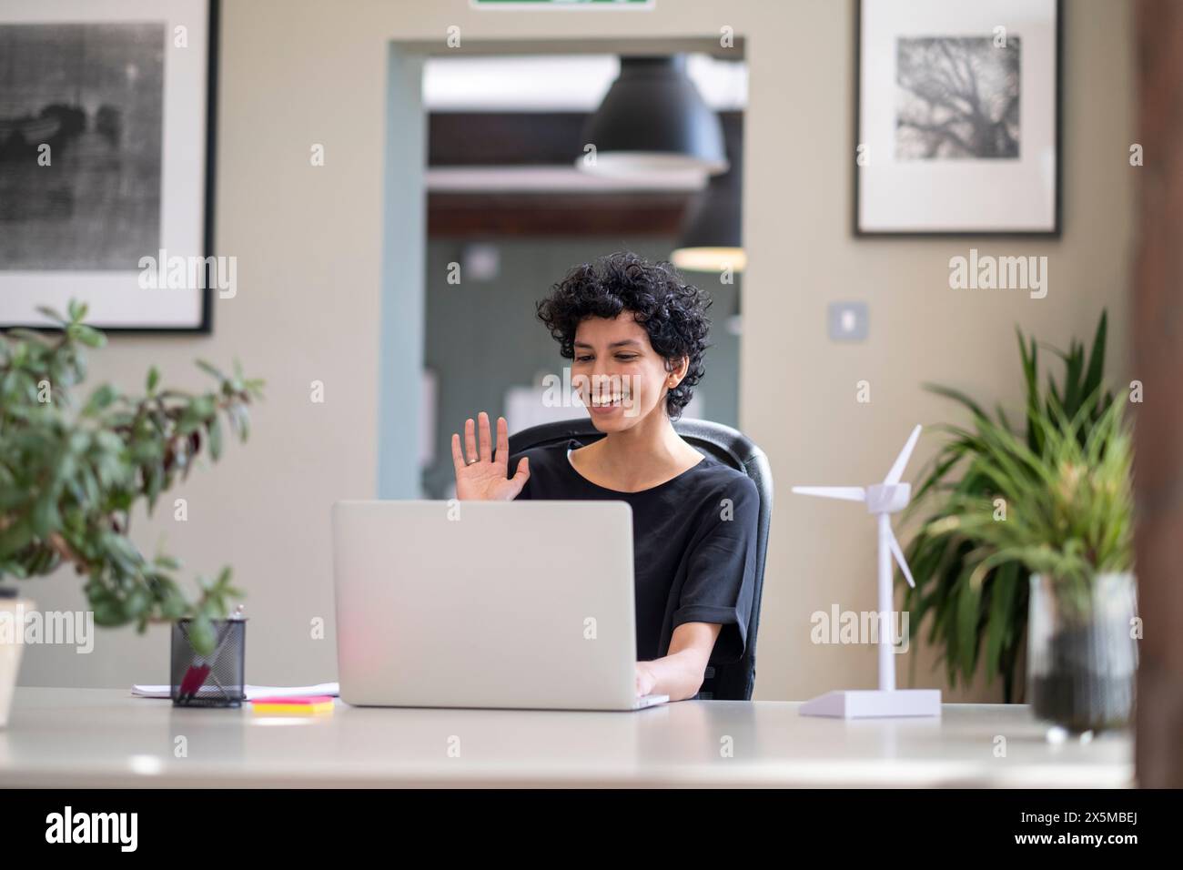 Young engineer having video call on laptop in office Stock Photo - Alamy