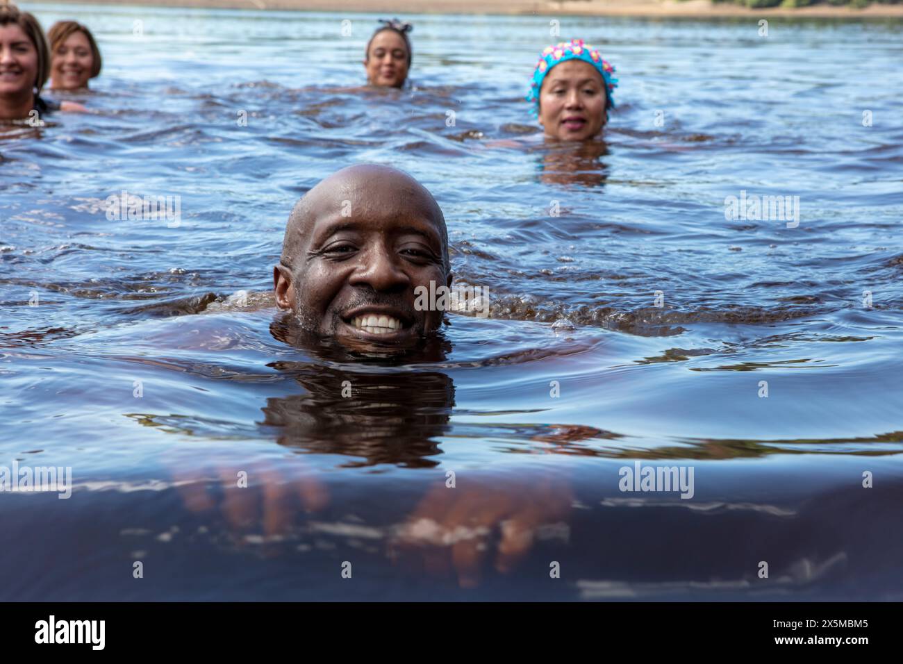 Group of smiling friends swimming in lake, Yorkshire, UK Stock Photo ...