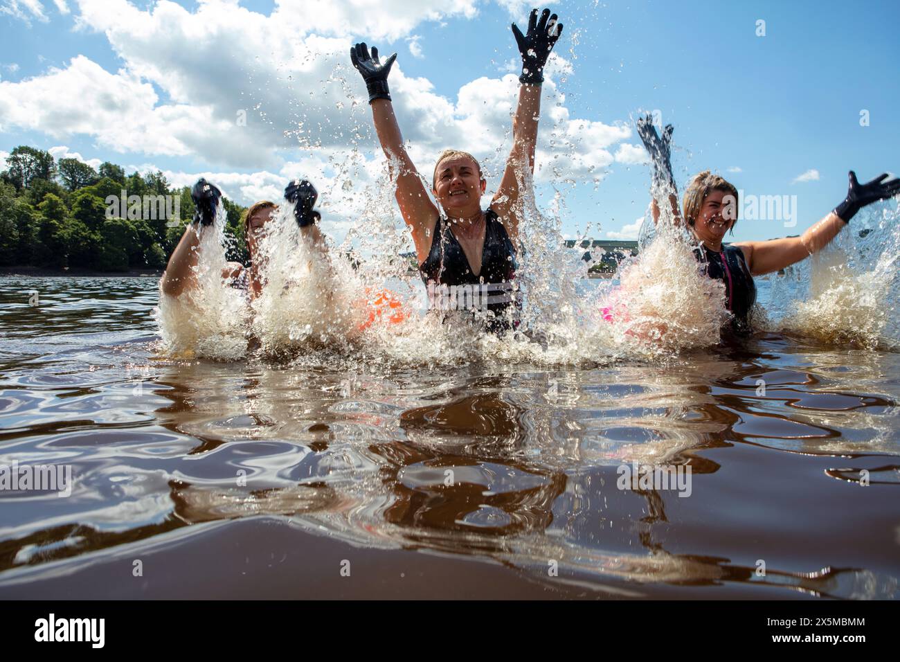 Female friends splashing water in lake, Yorkshire, UK Stock Photo - Alamy
