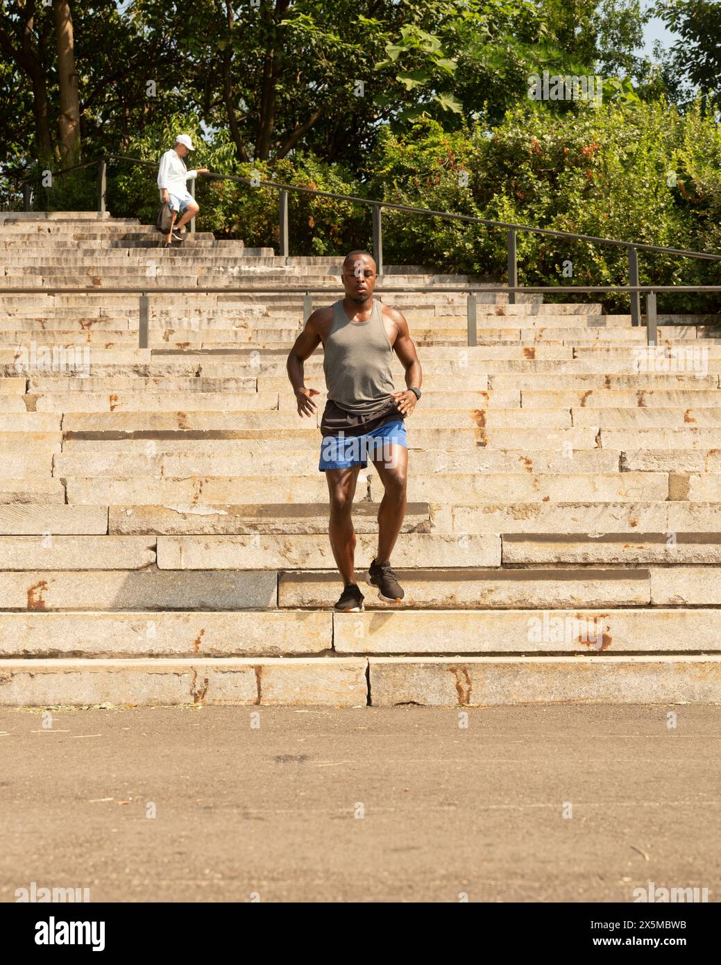 Athletic man running down steps Stock Photo - Alamy