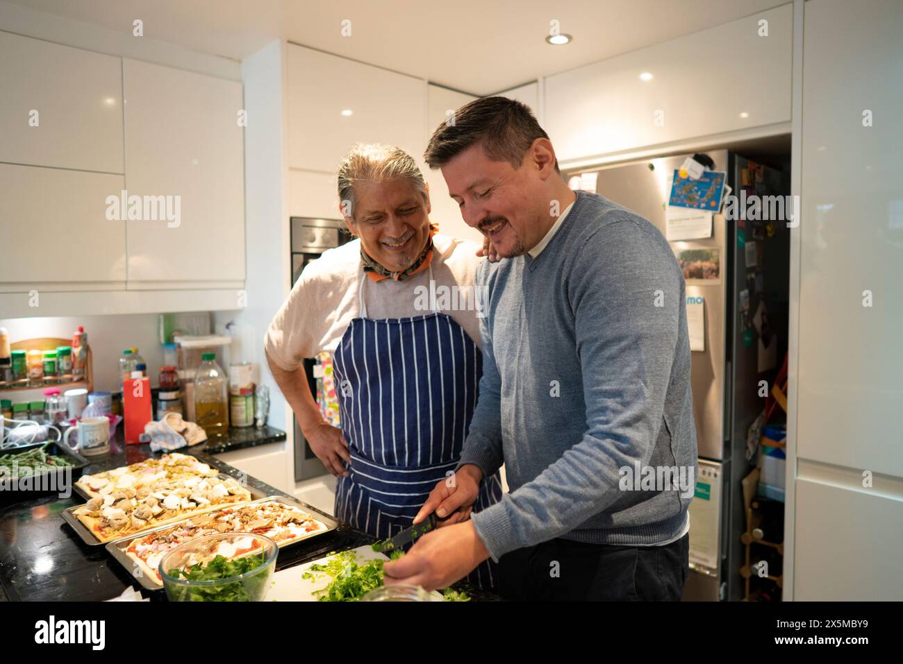 Smiling father son cutting hi-res stock photography and images - Alamy