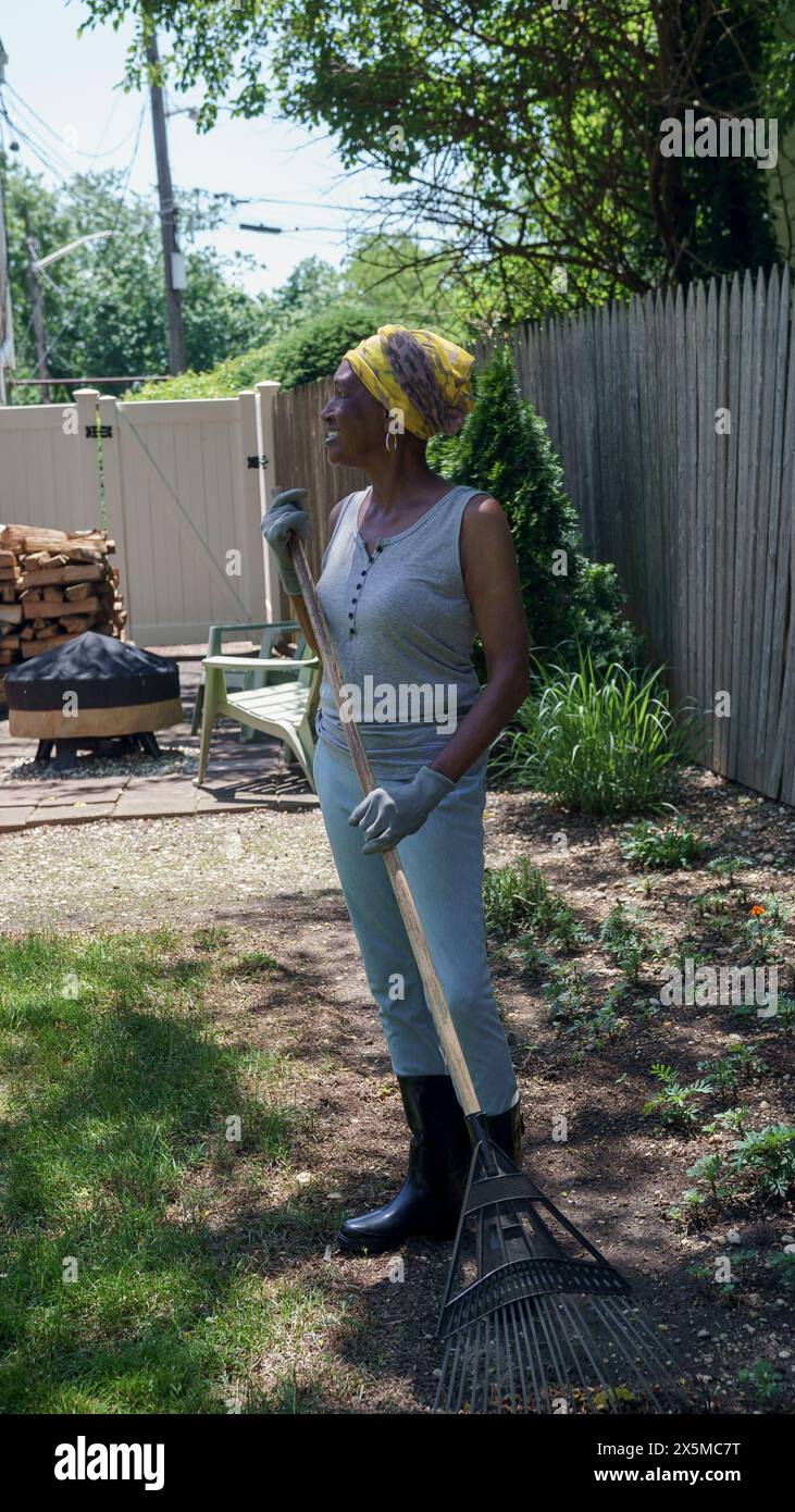 Senior woman working in backyard Stock Photo - Alamy