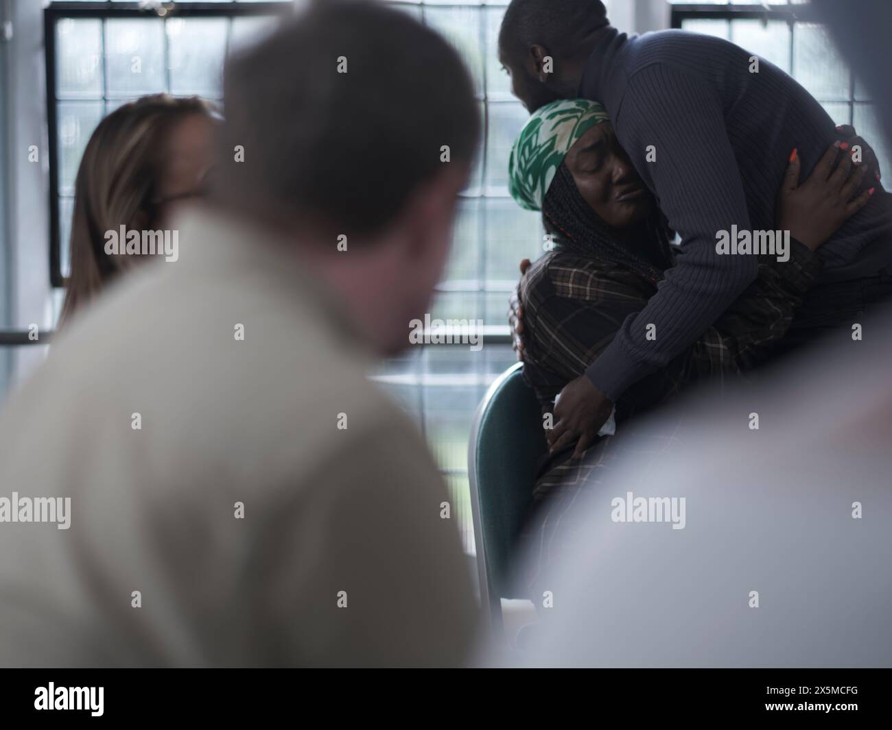People hugging in group therapy session Stock Photo - Alamy