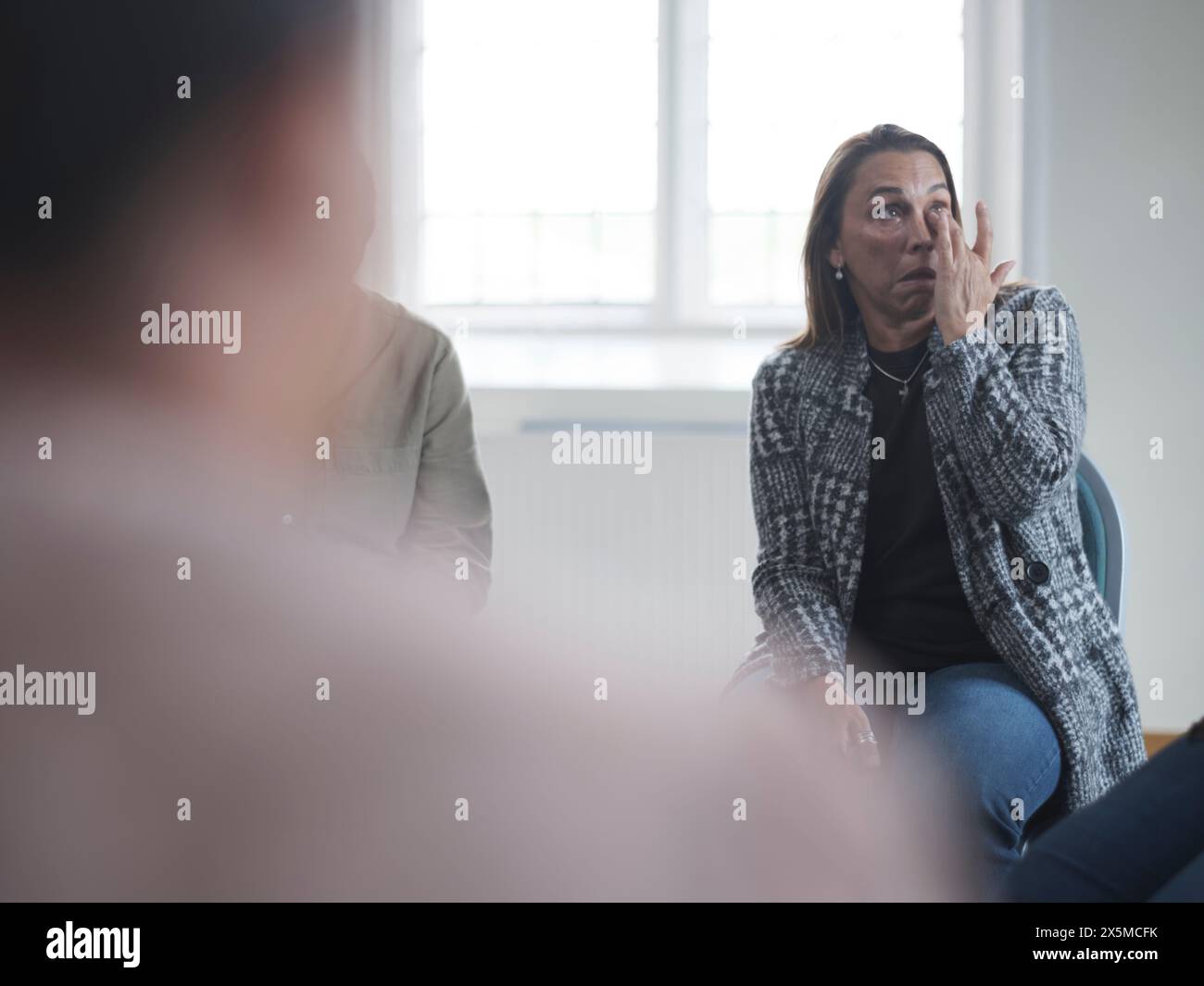 Woman crying in group therapy session Stock Photo - Alamy