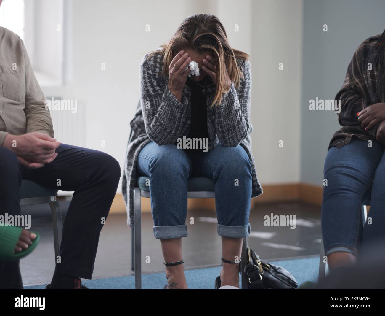 Woman crying in group therapy session Stock Photo - Alamy