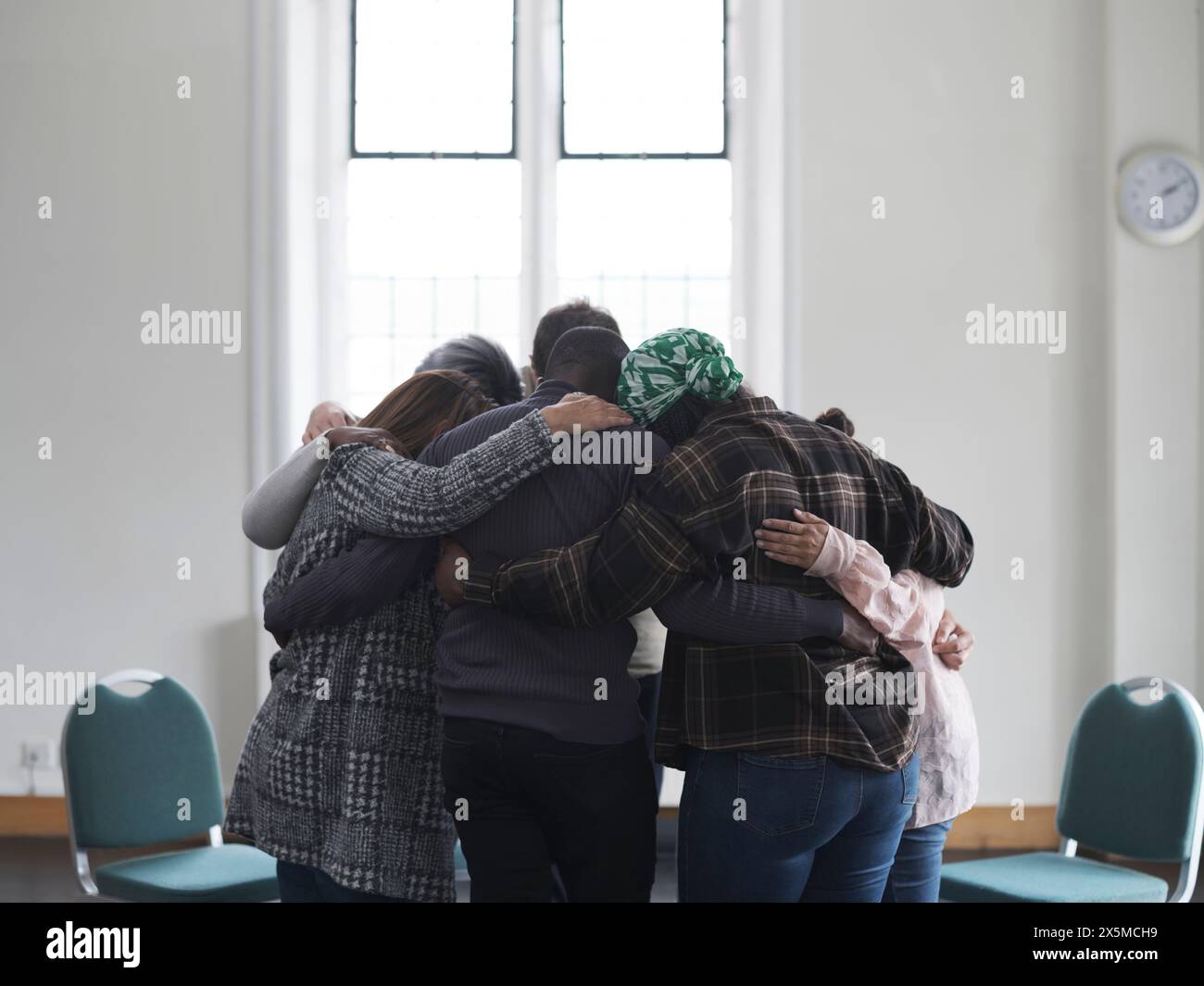 People hugging in group therapy session Stock Photo - Alamy