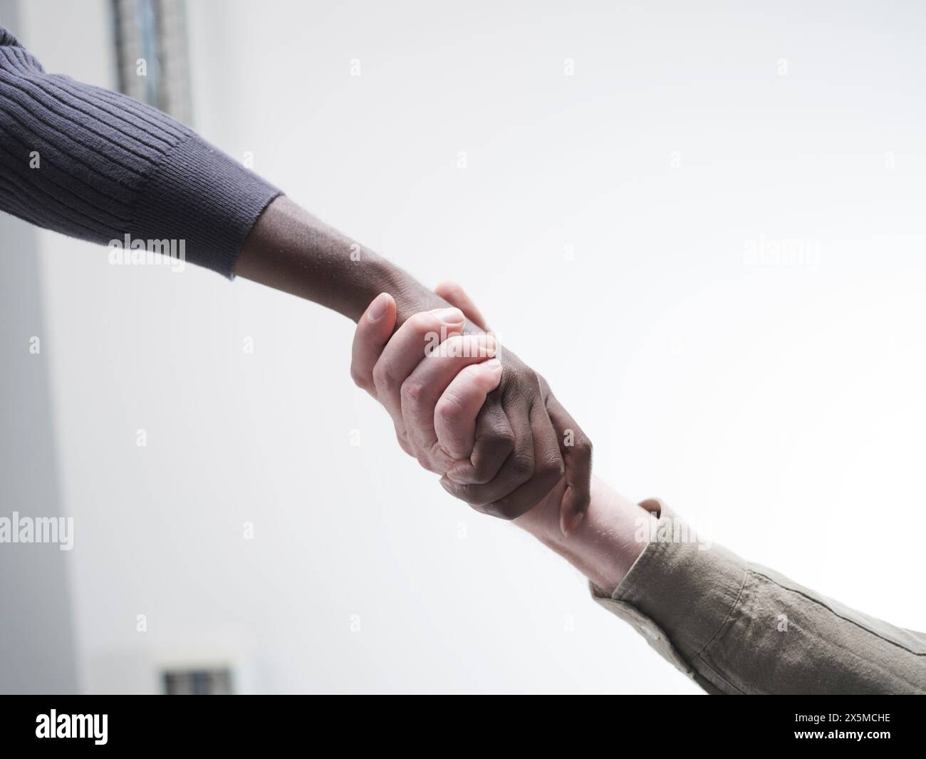 Men holding hands Stock Photo - Alamy