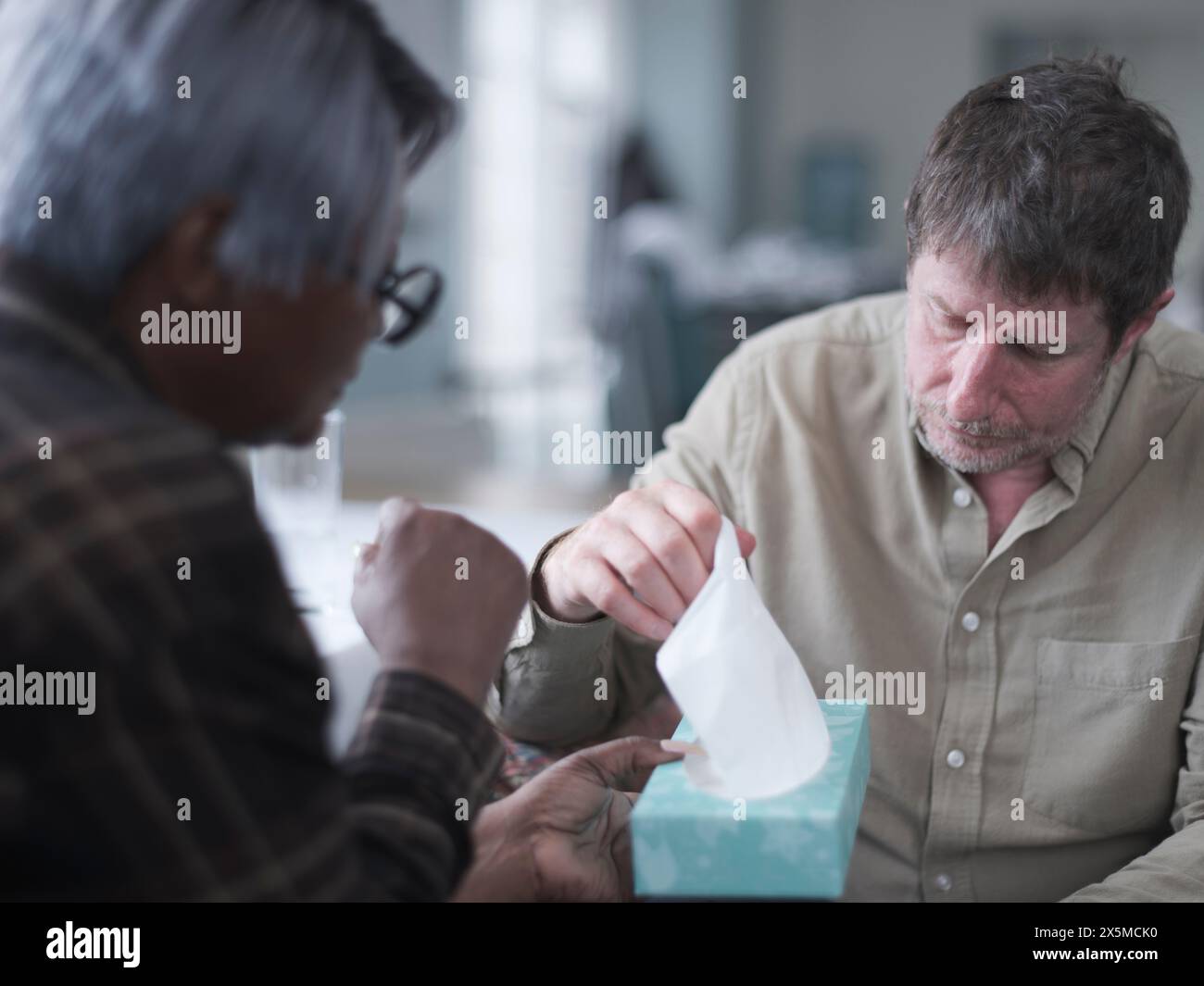 Therapist giving patient handkerchief in therapy session Stock Photo ...