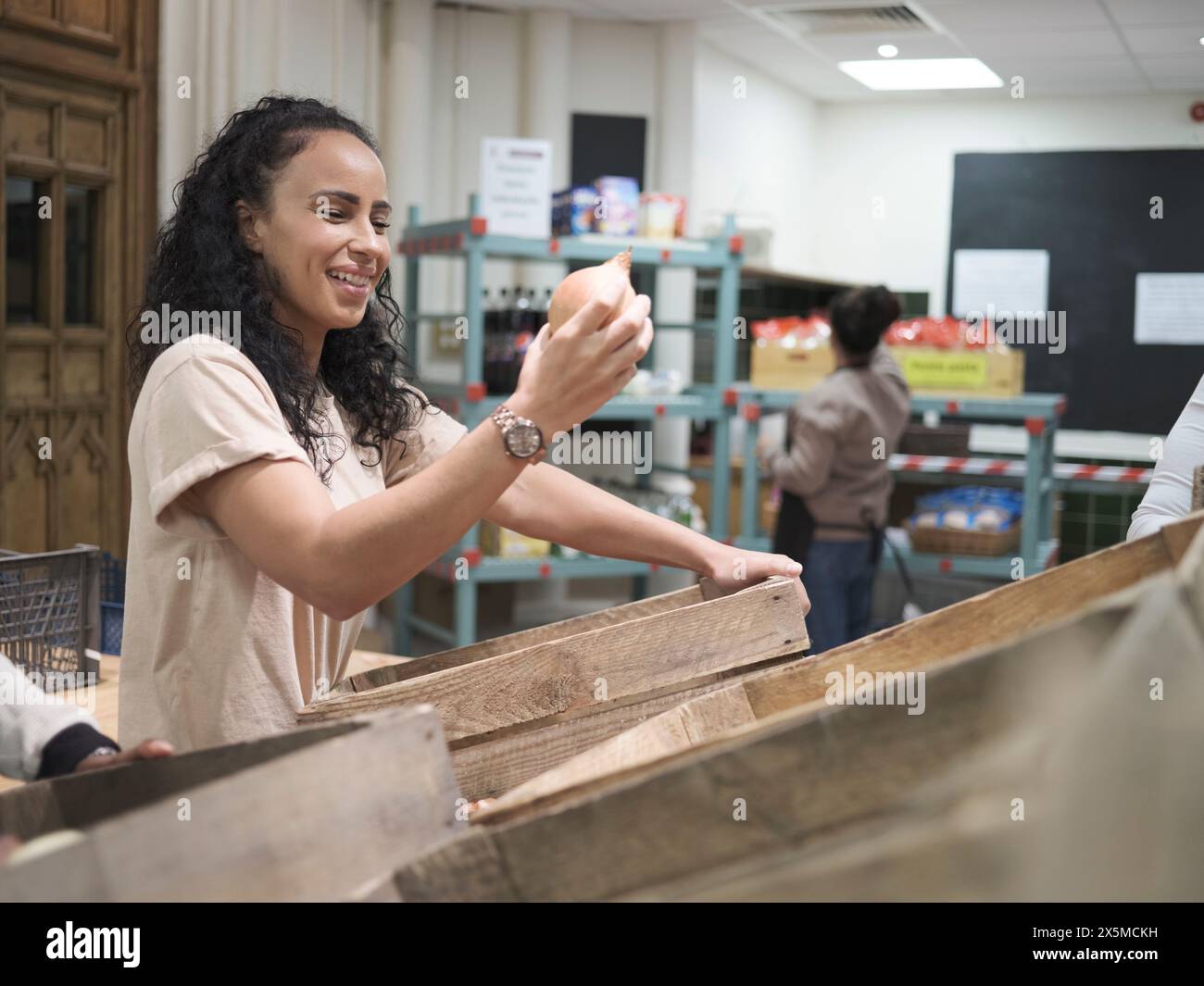 Volunteer working in community food center Stock Photo - Alamy