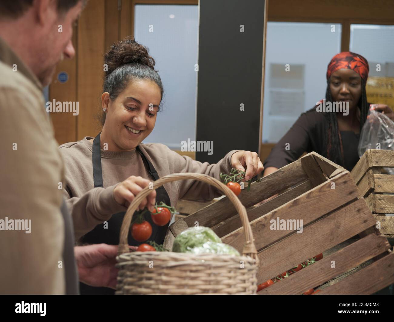 Volunteers sorting vegetables in community food center Stock Photo - Alamy