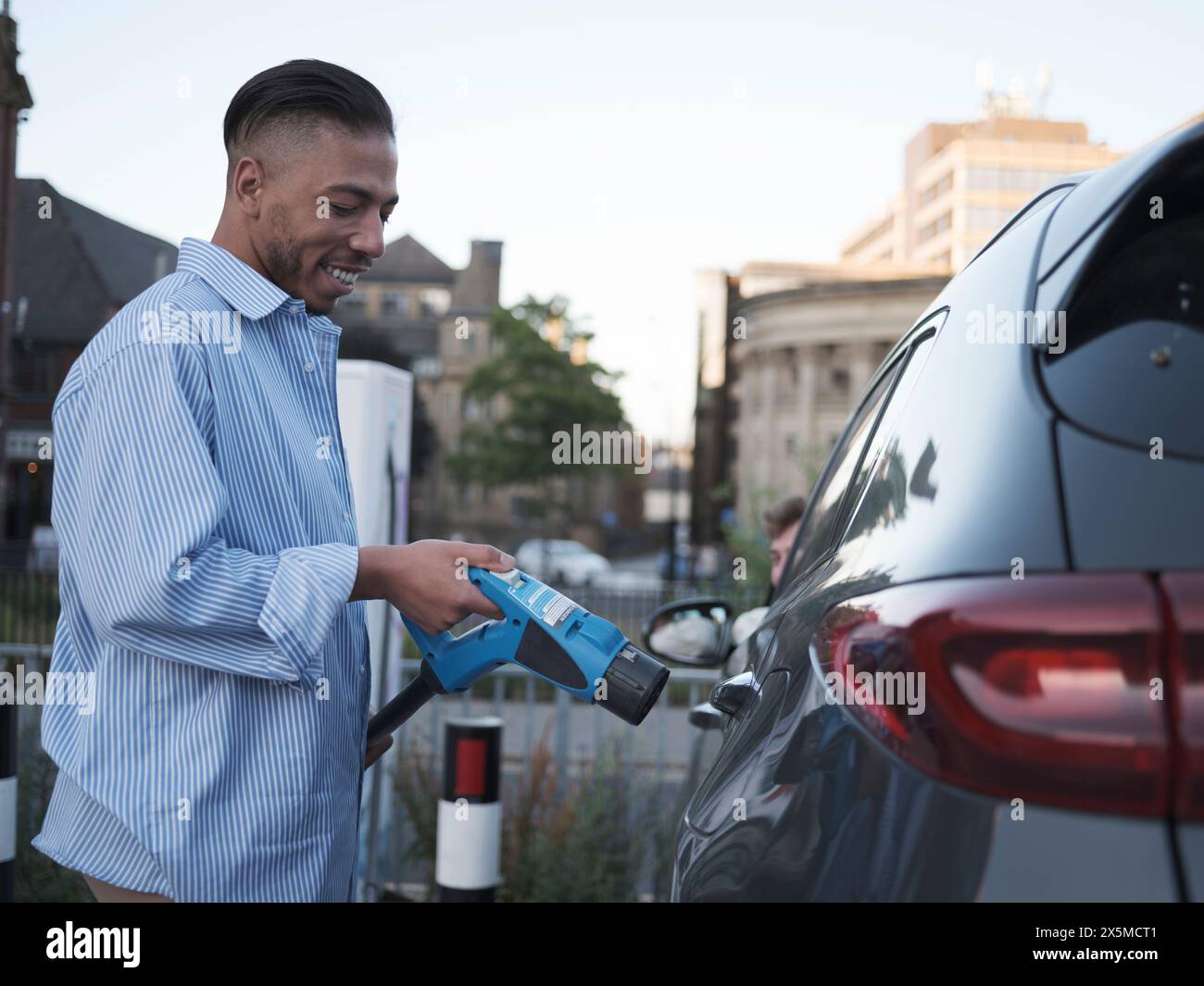 Man electric car charging uk hi-res stock photography and images - Alamy