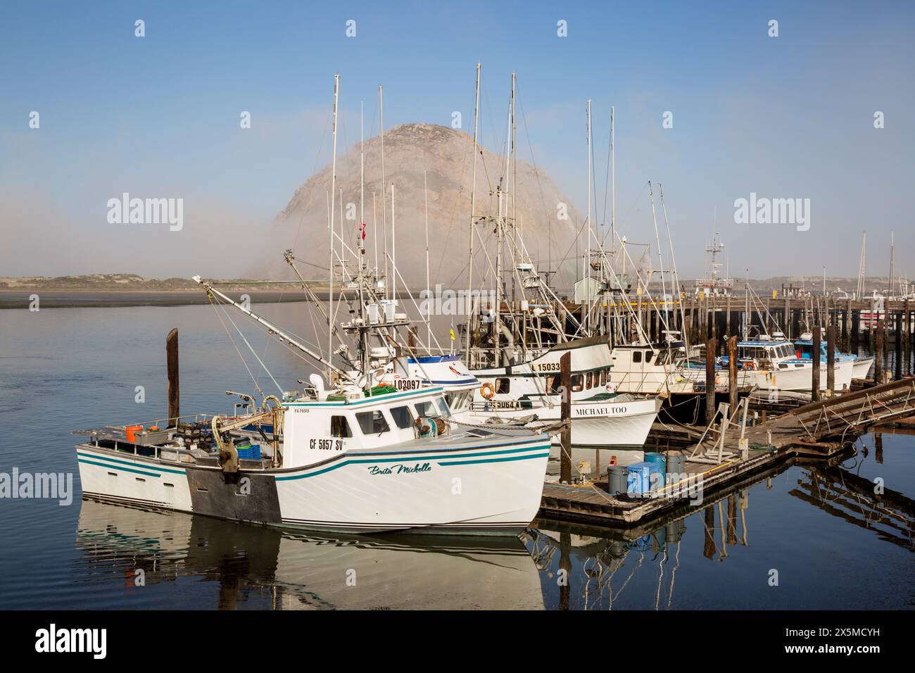 USA, California, Central Coast, Morro Bay. Morning fog clearing over Morro Rock. (Editorial Use ...