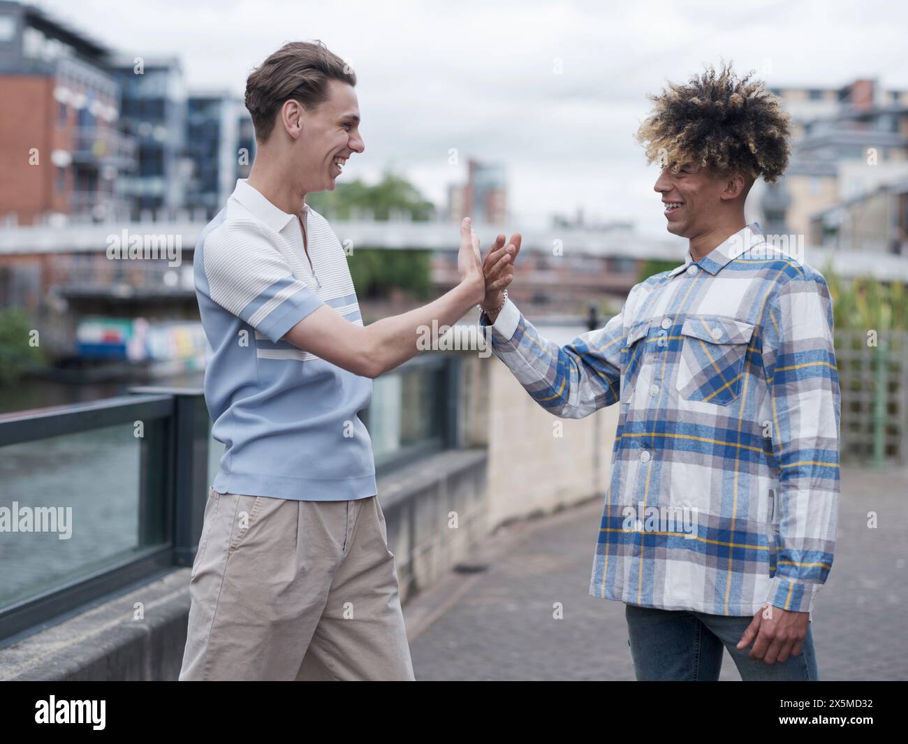 Young men doing handshake routine Stock Photo - Alamy