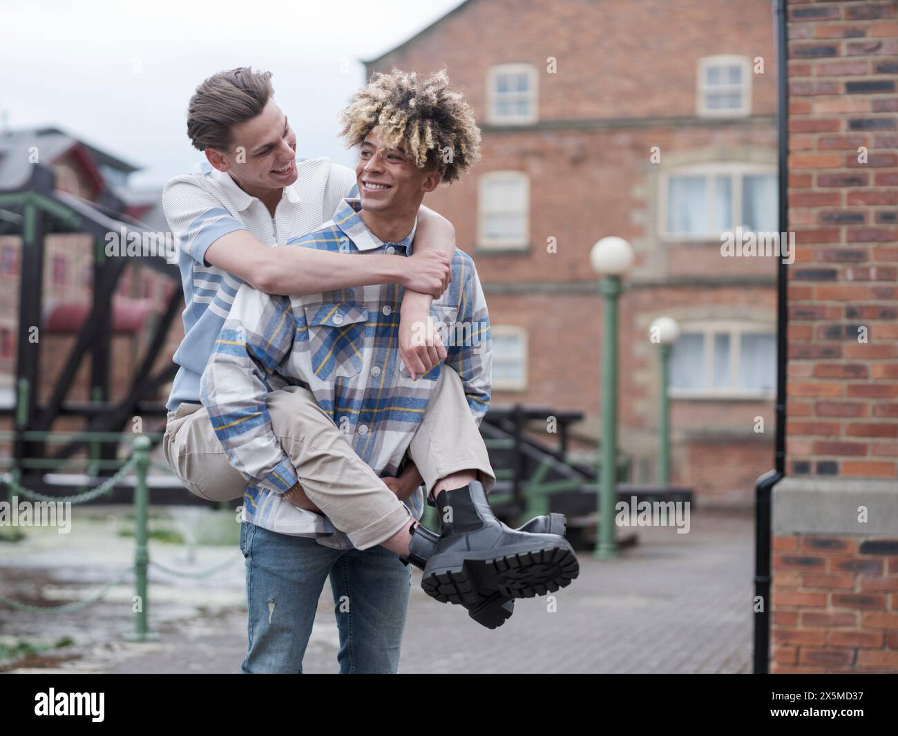 Gay couple piggyback ride hi-res stock photography and images - Alamy