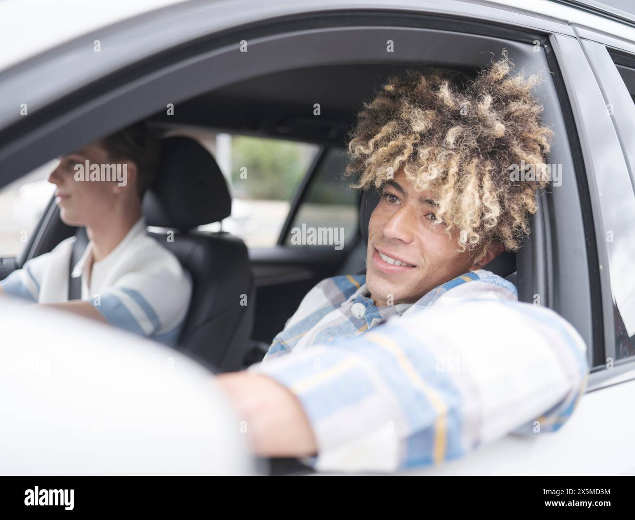 Male couple driving car Stock Photo - Alamy