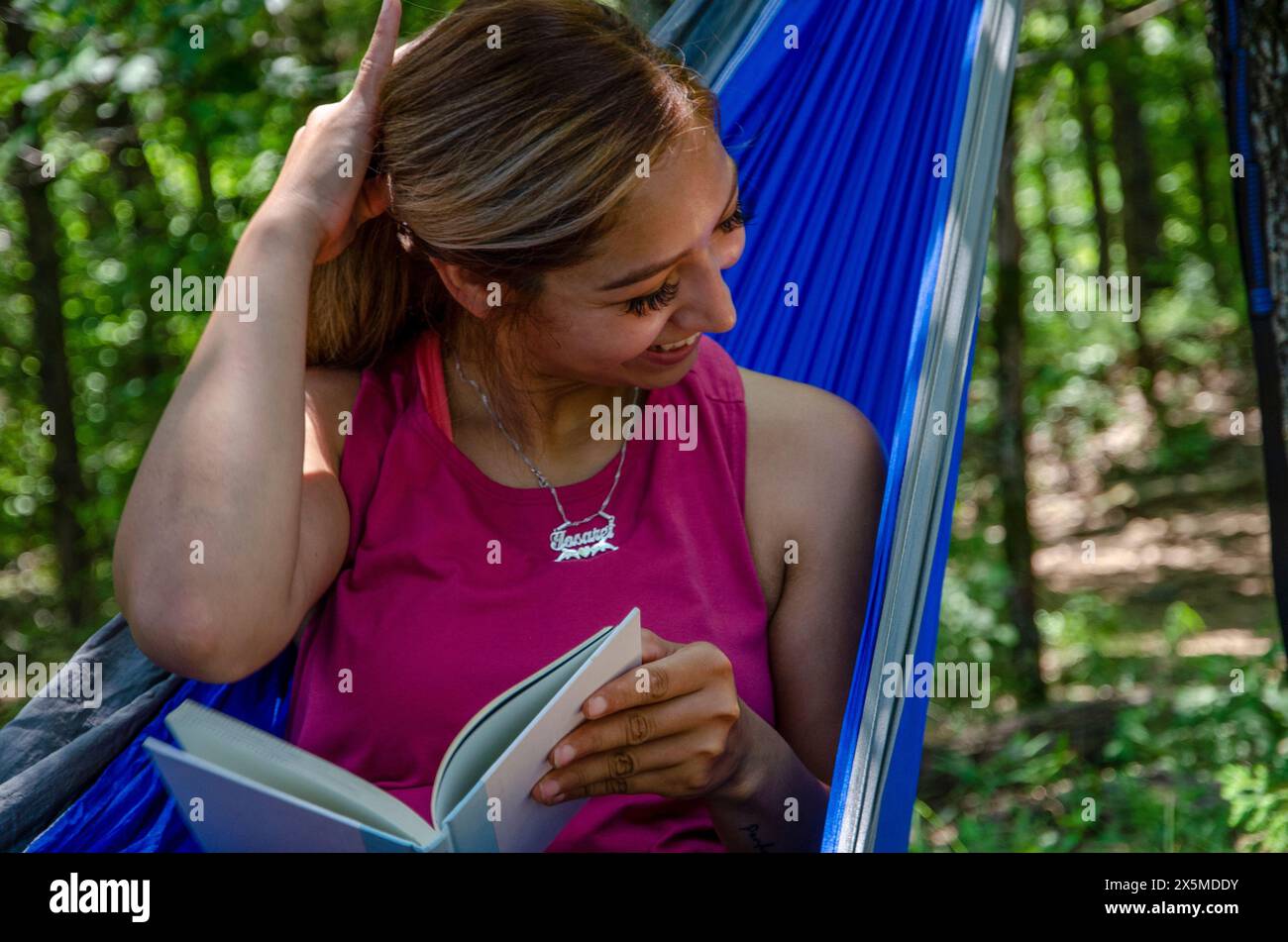 Woman reading book in forest hi-res stock photography and images - Alamy