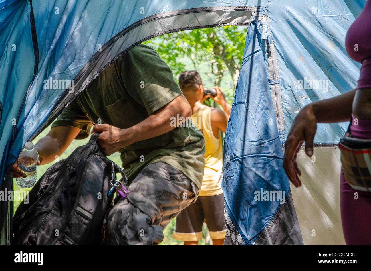 Young man entering tent hi-res stock photography and images - Alamy