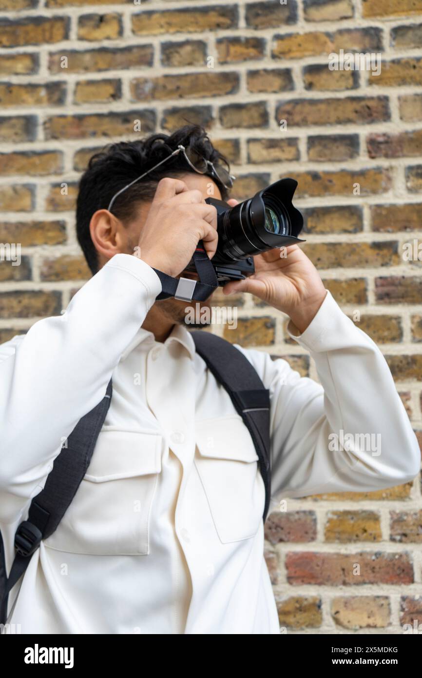Young man using camera Stock Photo - Alamy