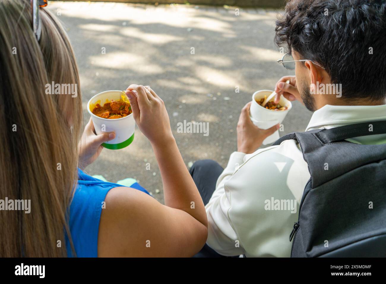 Two men eating food sitting hi-res stock photography and images - Alamy
