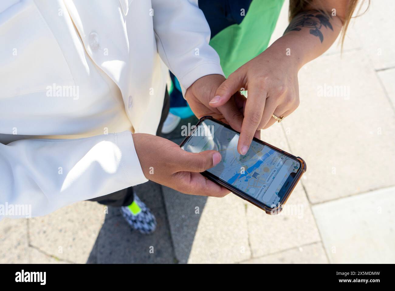Man and woman using maps on smartphone, close up Stock Photo - Alamy