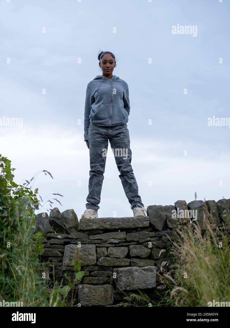 Girl balancing on stone wall hi-res stock photography and images - Alamy