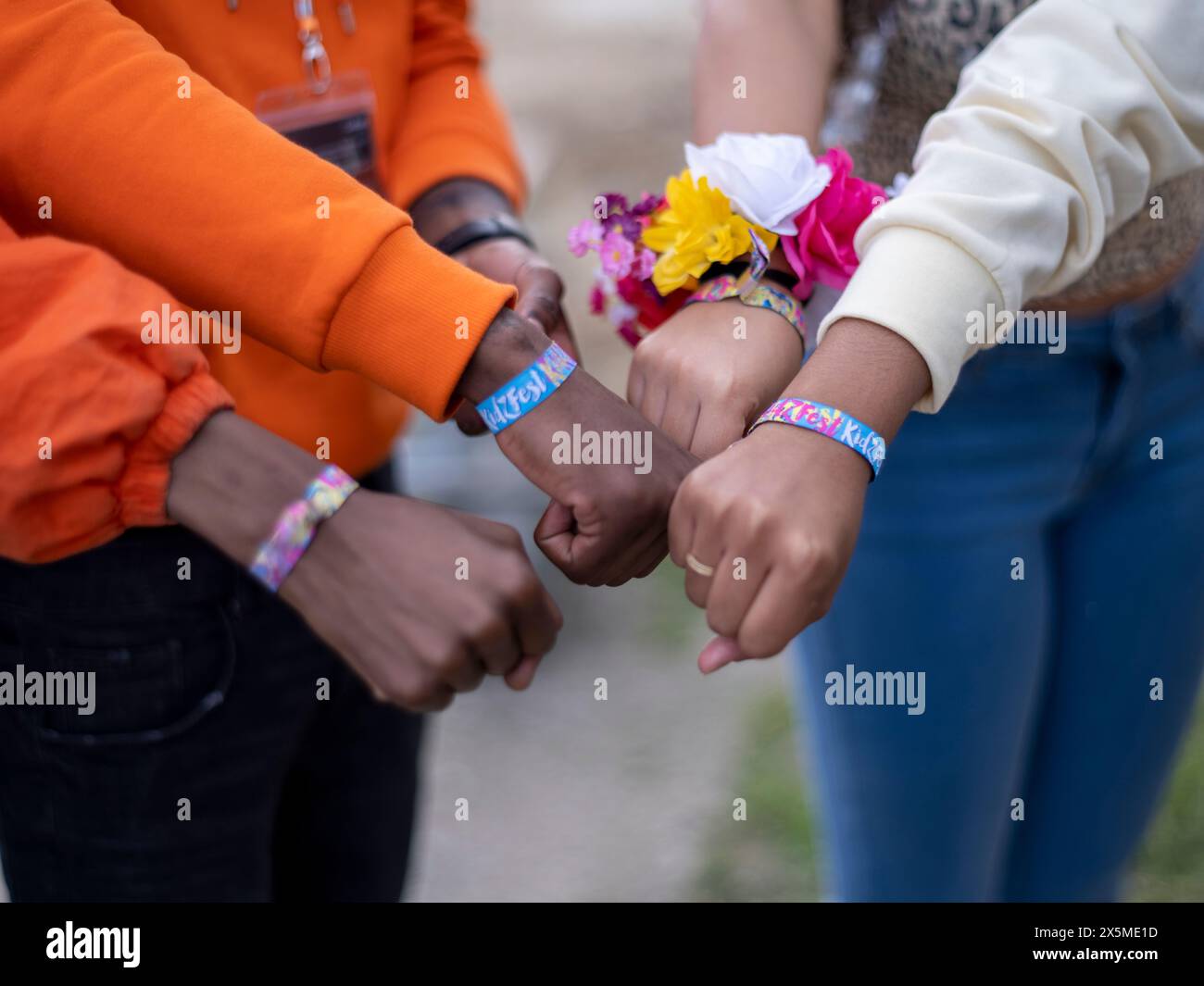 Group of teenage (16-17) friends demonstrating hand bands Stock Photo ...