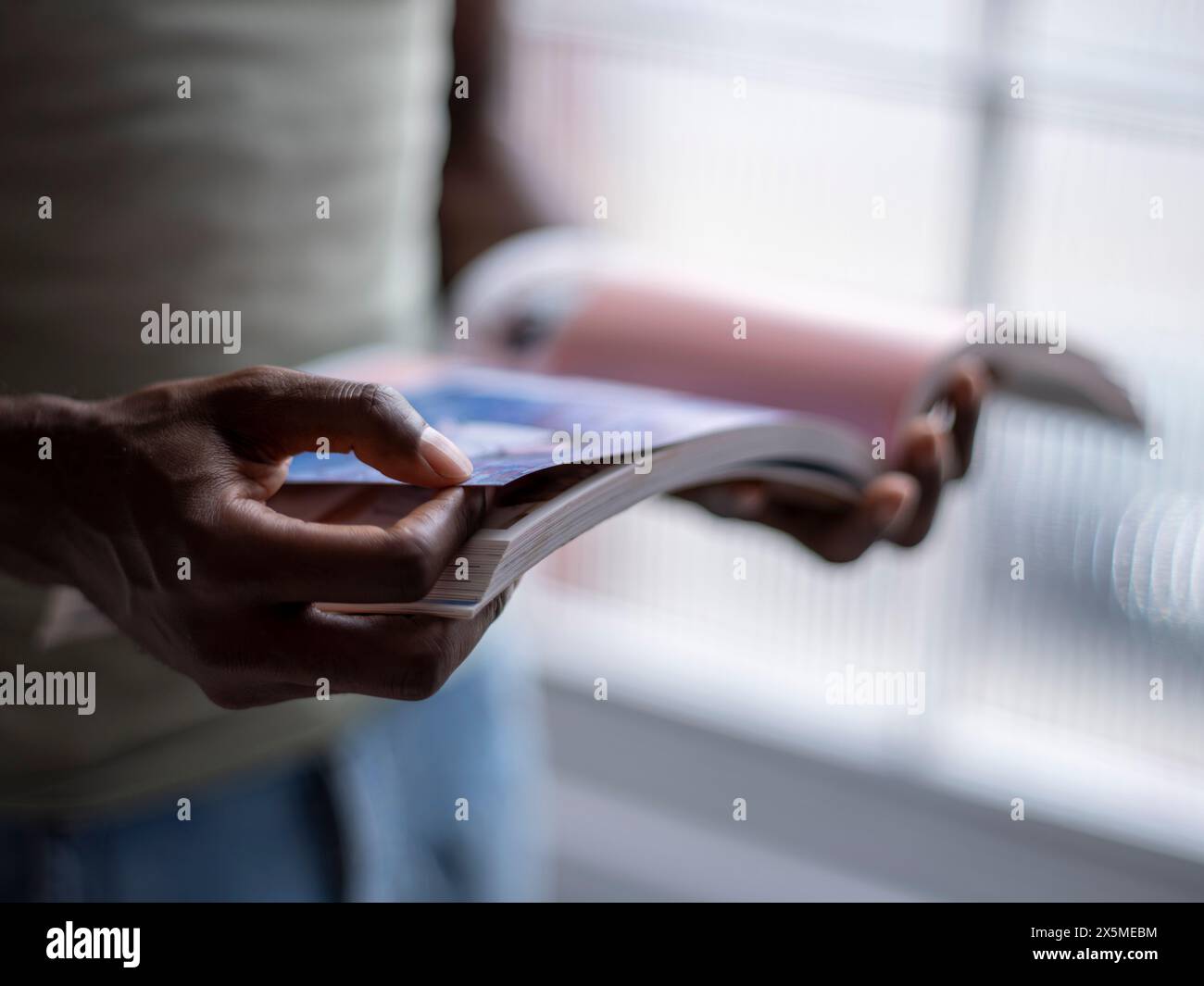 Close-up of person holding open book Stock Photo - Alamy