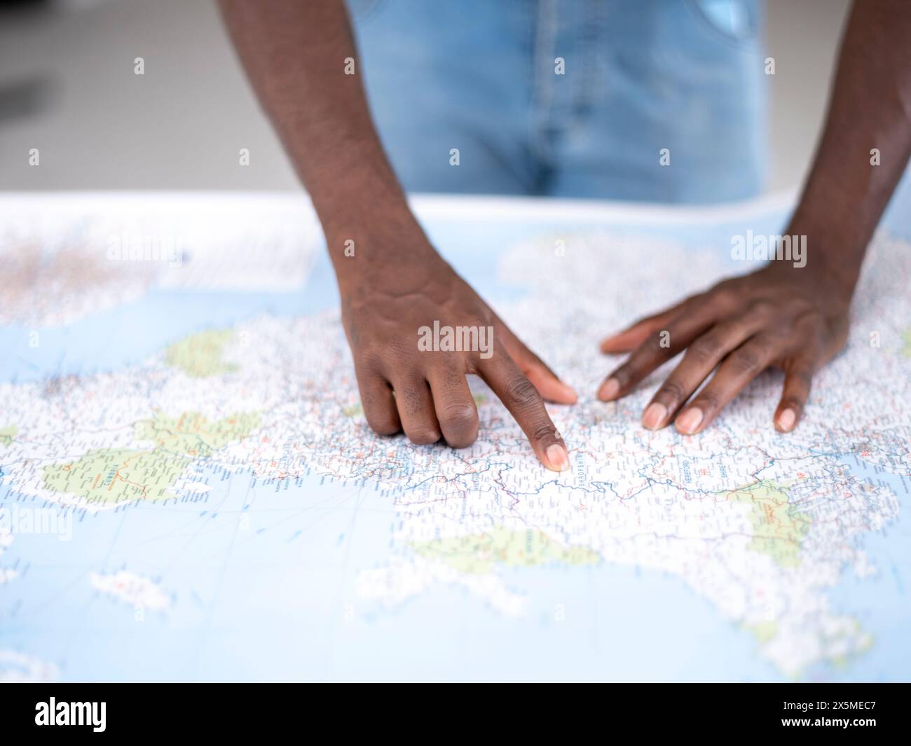 Close-up of hands pointing at map on table Stock Photo - Alamy
